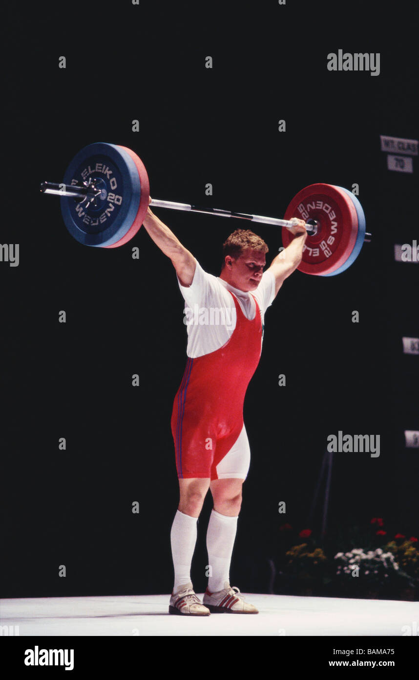 Olympic style weightlifter in action Stock Photo - Alamy