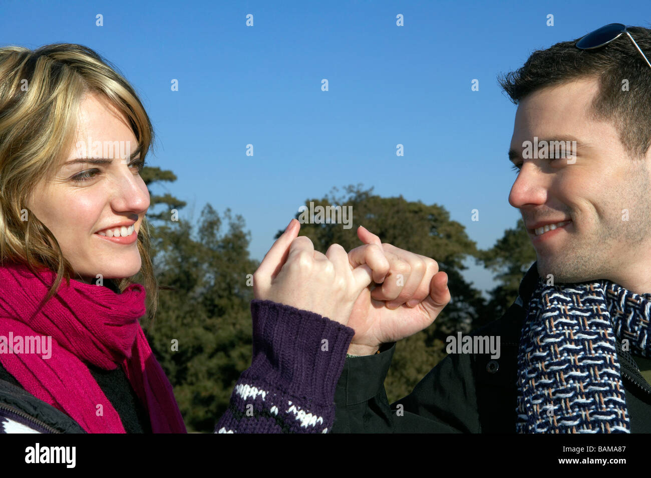 Young Couple Making Pinky Promise Stock Photo - Alamy