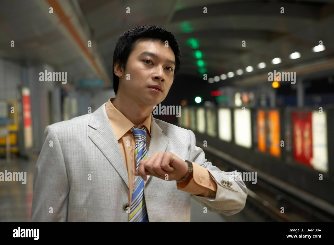 Businessman checking watch waiting train hi-res stock photography and ...