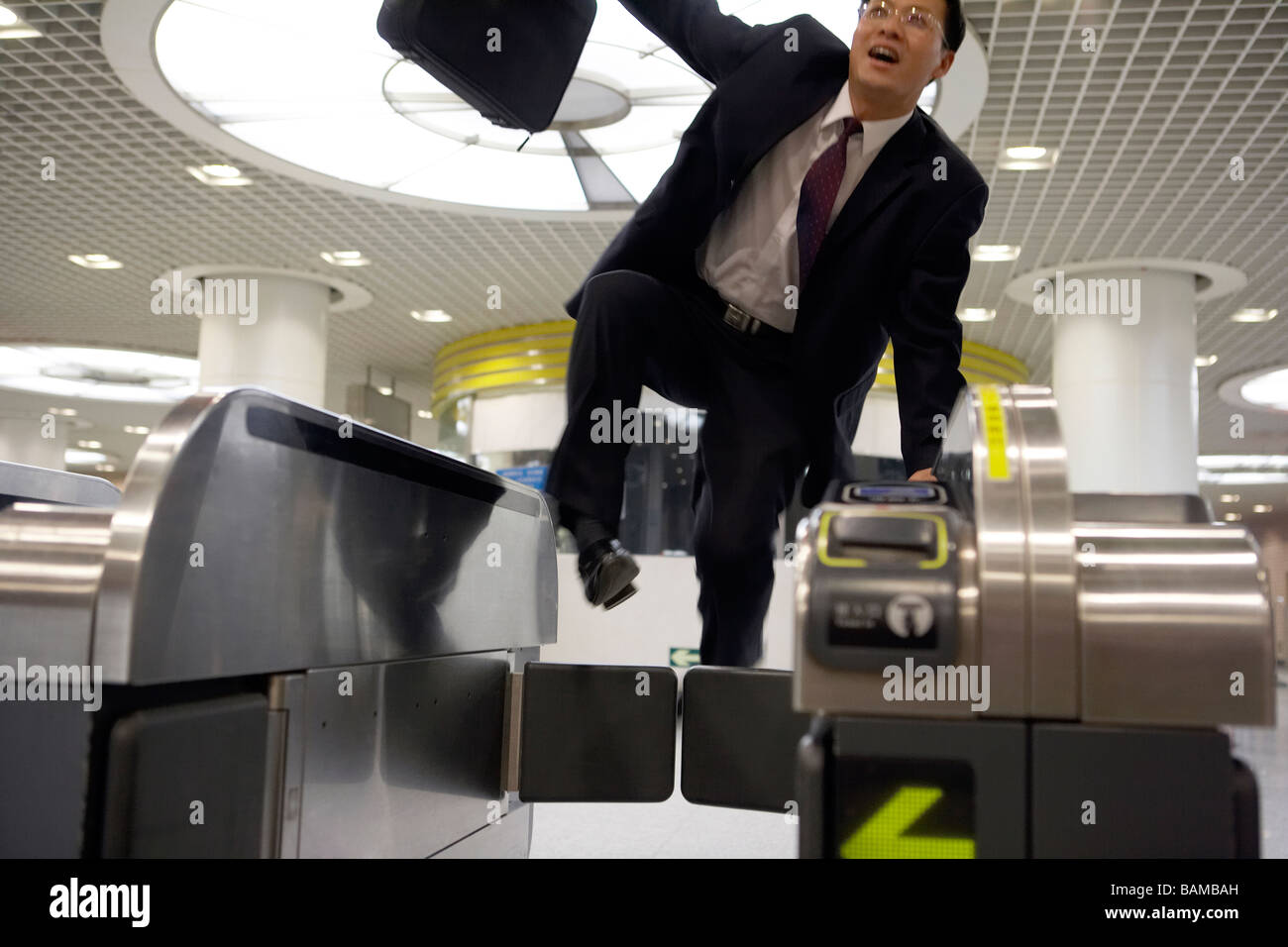 A Man Jumping Over A Ticket Gate At A Subway Station Stock Photo - Alamy