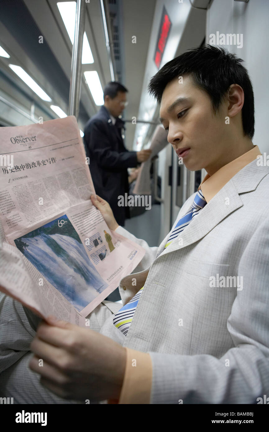 Man Reading Newspaper On Train Stock Photo - Alamy