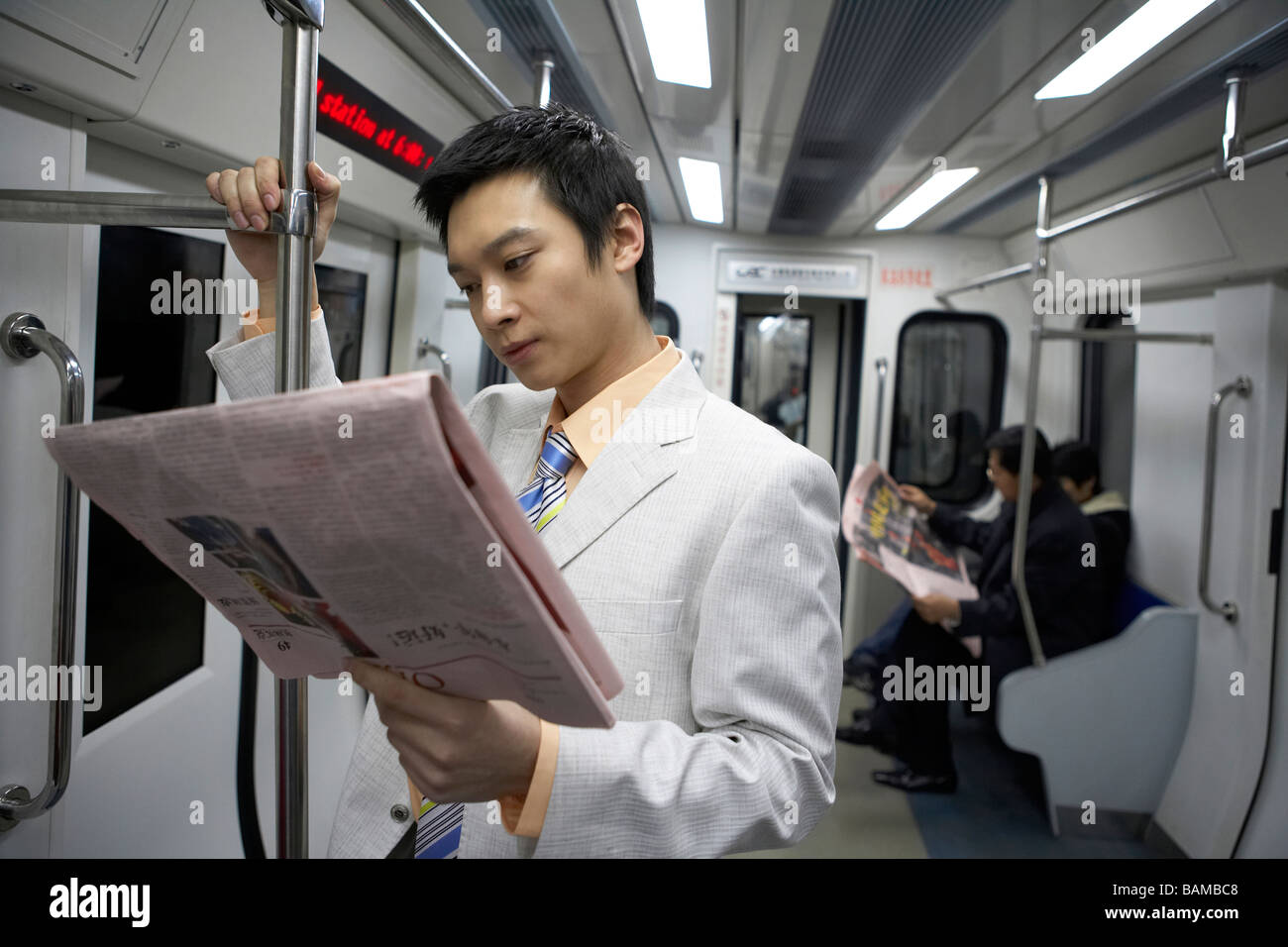 Man Standing On Train, Reading Newspaper Stock Photo - Alamy