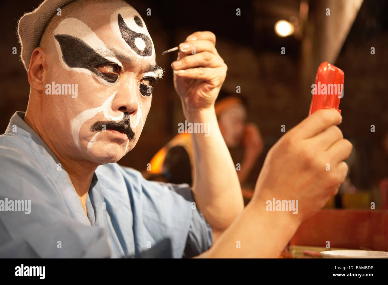 Performer Applying Face Paint With Brush Stock Photo - Alamy