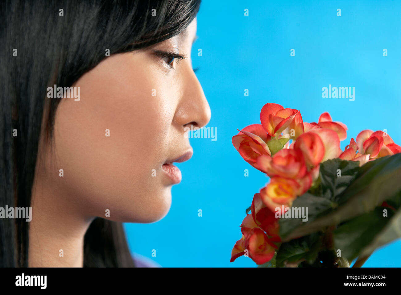 Young Woman Smelling A Flower Stock Photo - Alamy