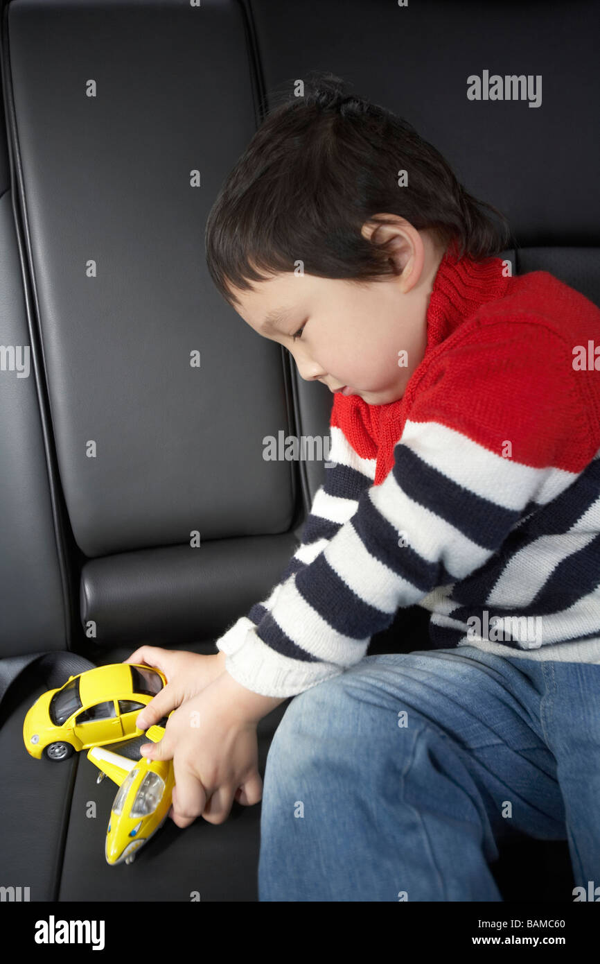 Young Child Playing With Toys In Car Stock Photo - Alamy