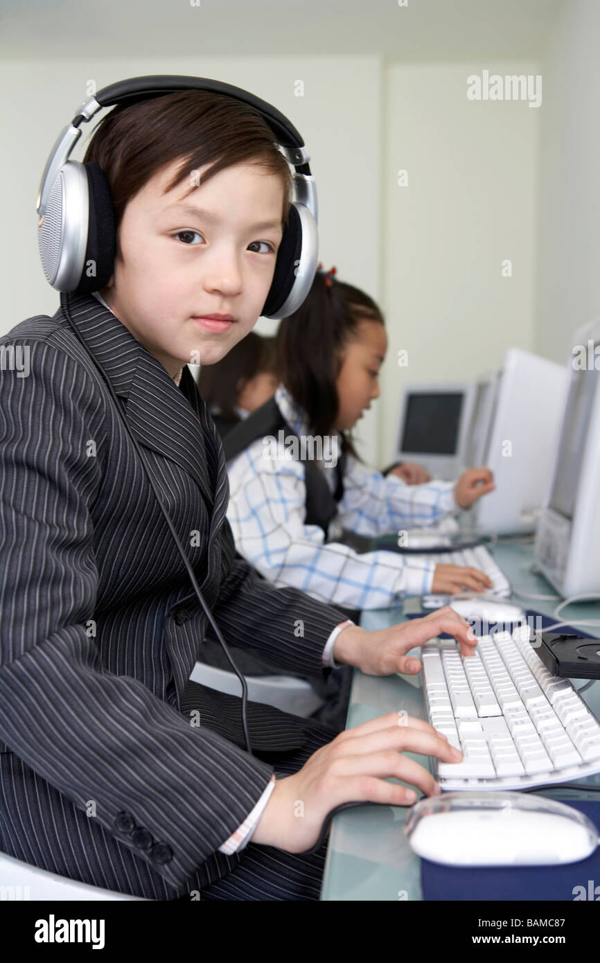 Young Boy Sitting At Computer Stock Photo - Alamy