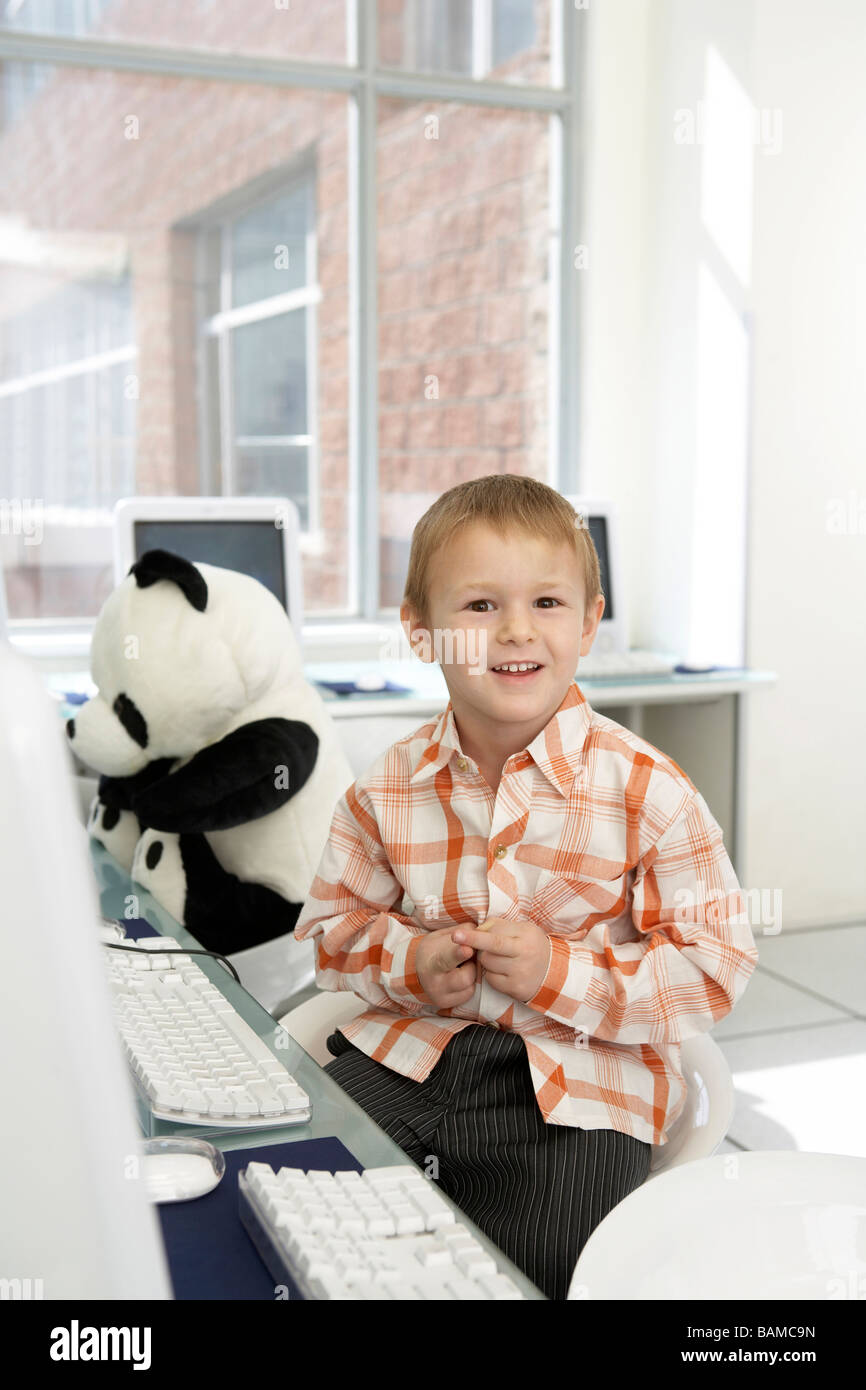 Boy Sitting At Computer Desk Stock Photo - Alamy