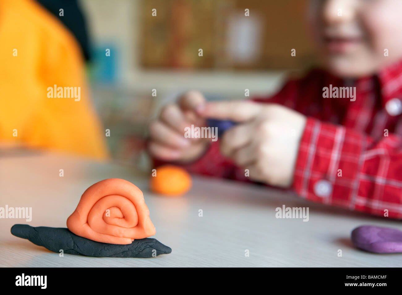 Orange And Black Play Dough Snail Stock Photo - Alamy
