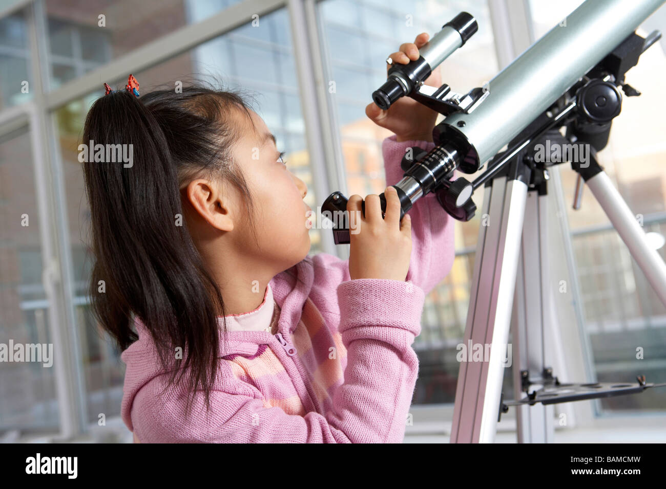 Girl Looking Through Telescope Stock Photo - Alamy