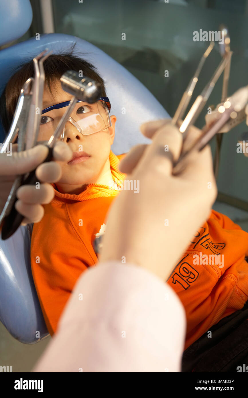 Small Boy Scared Of Dentist Tools Stock Photo - Alamy