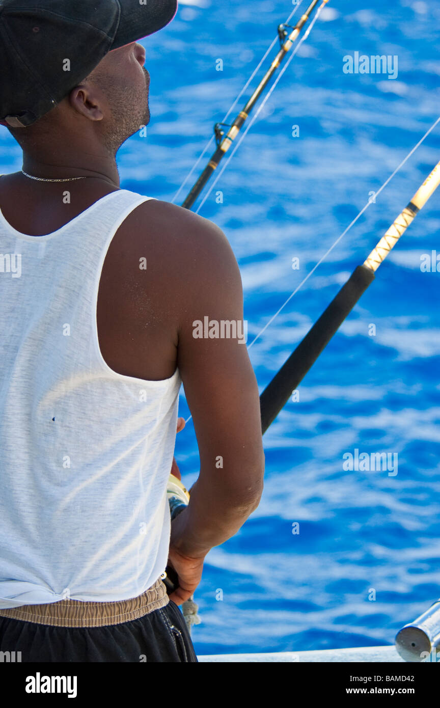 Fisherman with fishing rod big game fishing on boat Mauritius | Angler ...