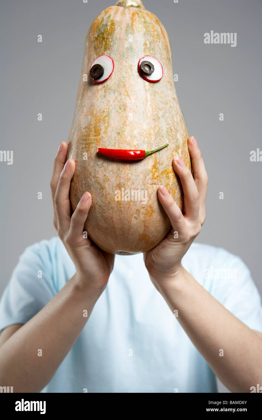 Male Covering Face With Vegetable Mask Stock Photo - Alamy