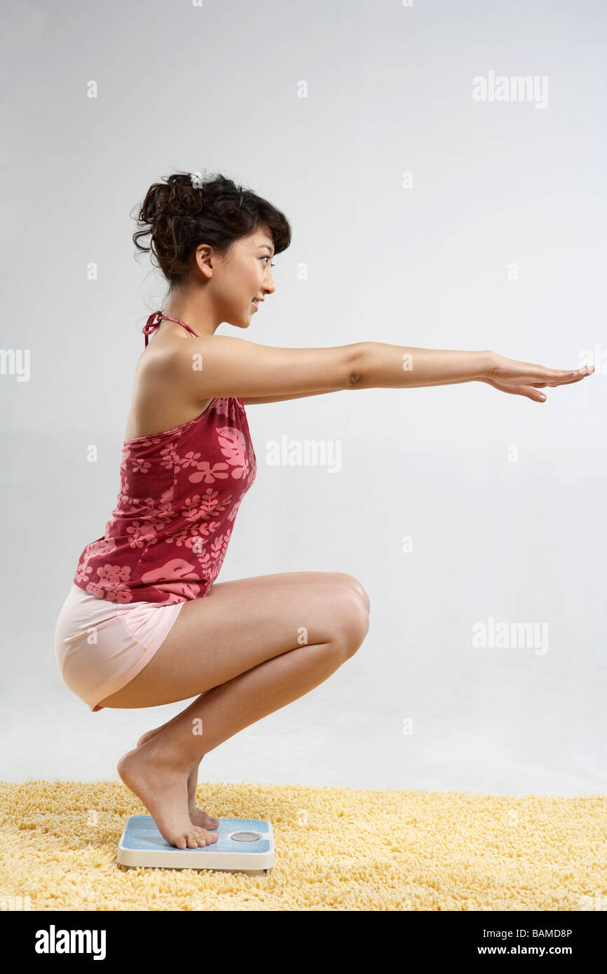 Young Woman Standing On Scales Stock Photo - Alamy