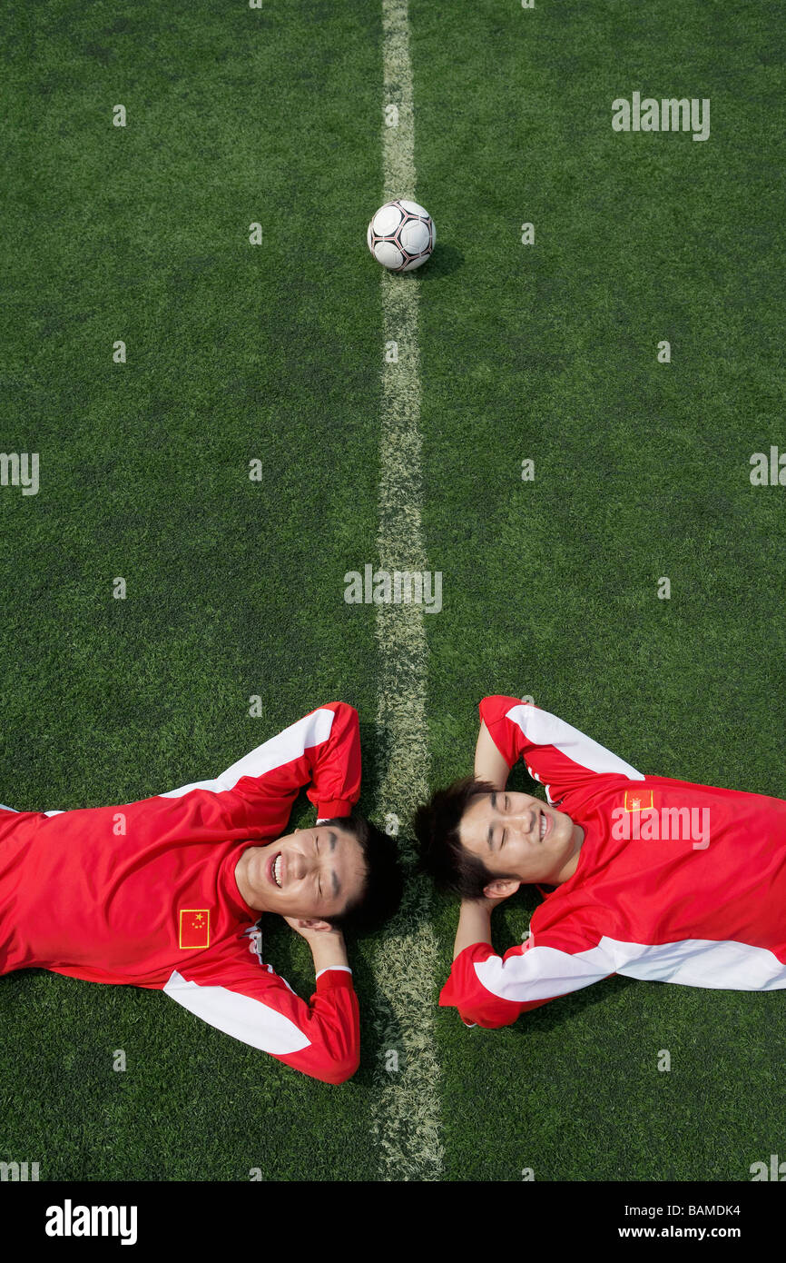 Soccer Players Lying Down On Soccer Field Stock Photo - Alamy