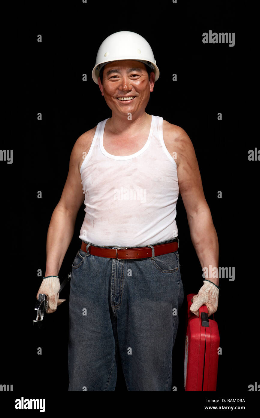 Man Wearing A Hard Hat Holding A Tool Kit Stock Photo - Alamy
