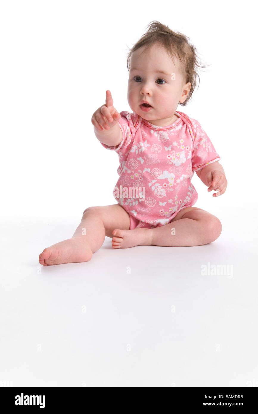 Sitting toddler pointing with her finger Stock Photo - Alamy