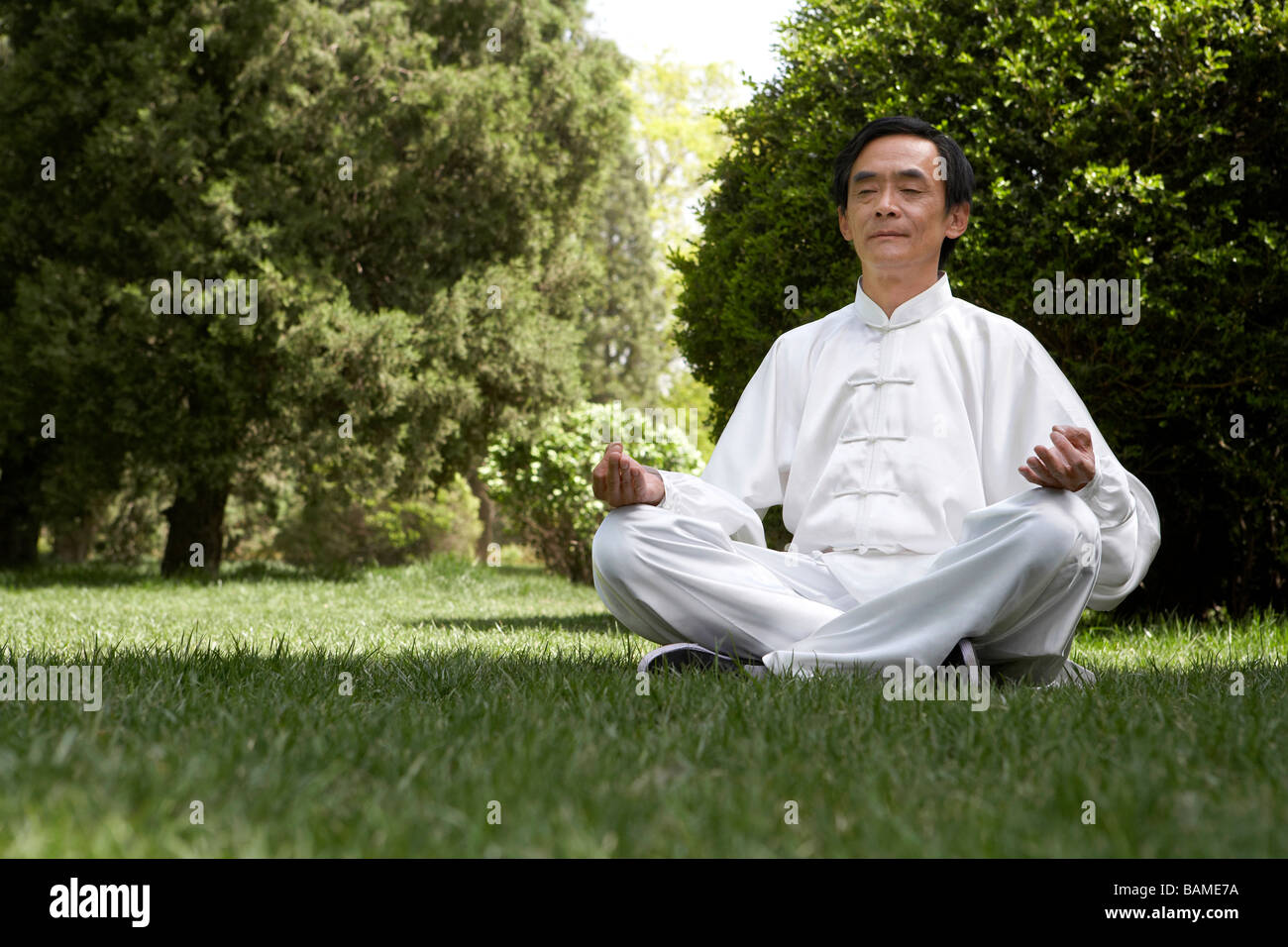 Man Meditating In Garden Stock Photo - Alamy