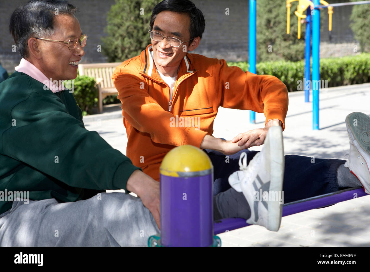 Two Senior Males Stretching Their Legs Before Work Out Stock Photo - Alamy