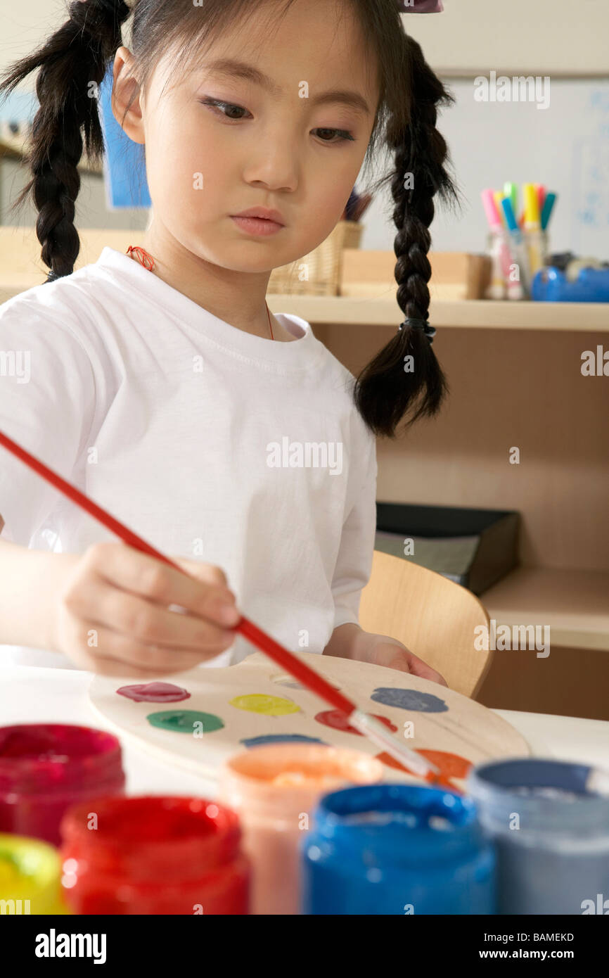 Girl Painting In Classroom Stock Photo - Alamy