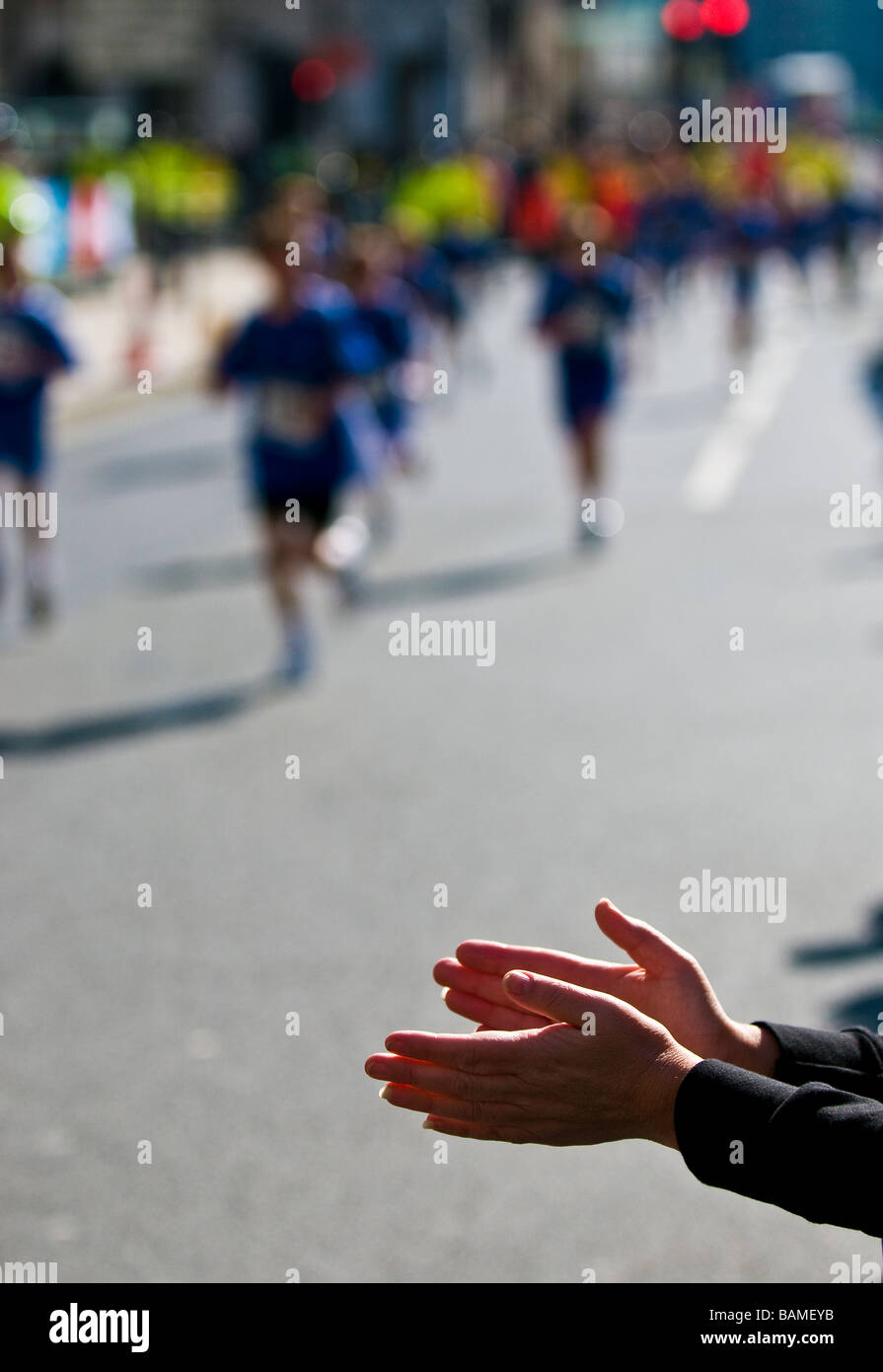 A spectator applauding runners in the London Marathon. Photo by Gordon ...