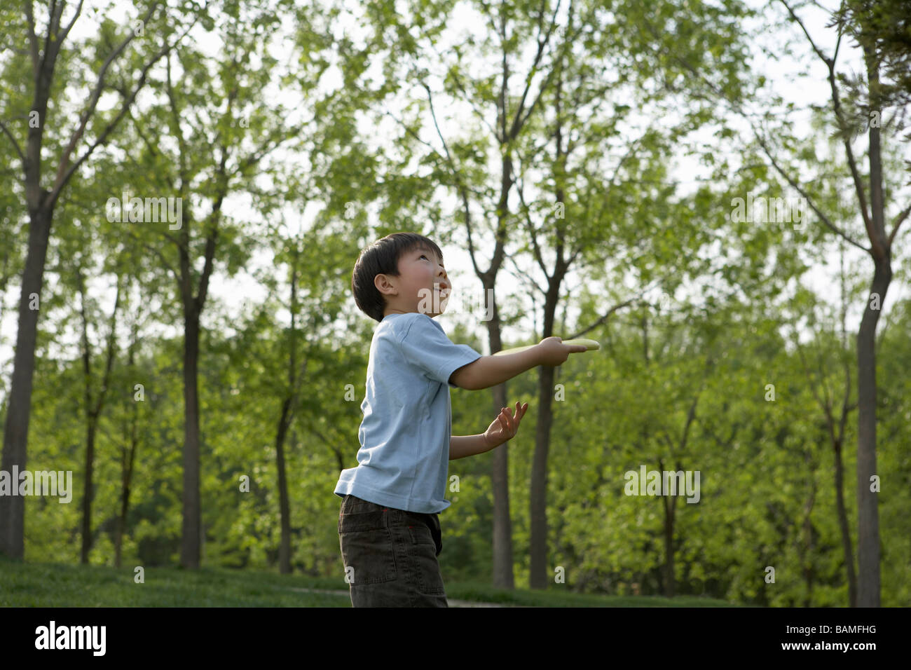 Young Boy Playing In The Park Stock Photo - Alamy