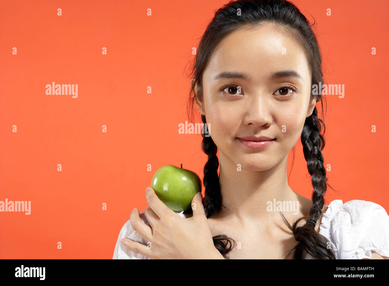 Young Girl With An Apple On Her Shoulder Stock Photo - Alamy
