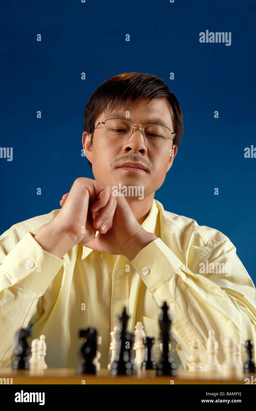 Portrait Of A Man Concentrating On A Chess Game Stock Photo - Alamy