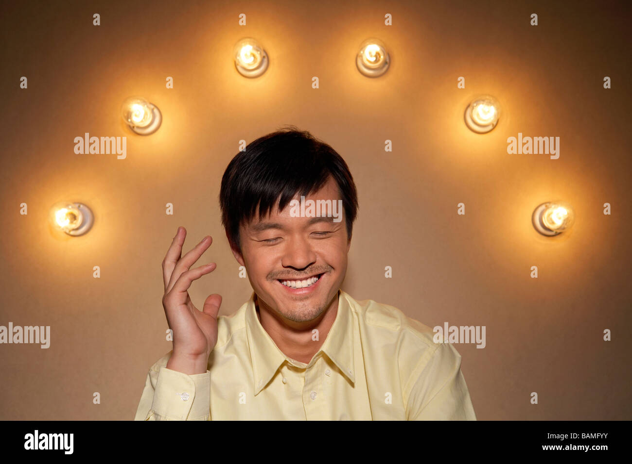 Portrait Of Young Man Surrounded By Lightbulbs, Laughing Stock Photo ...