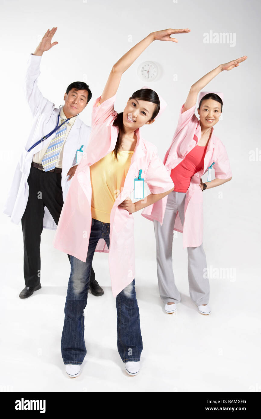Nurses And Doctor Stretching To One Side Stock Photo - Alamy