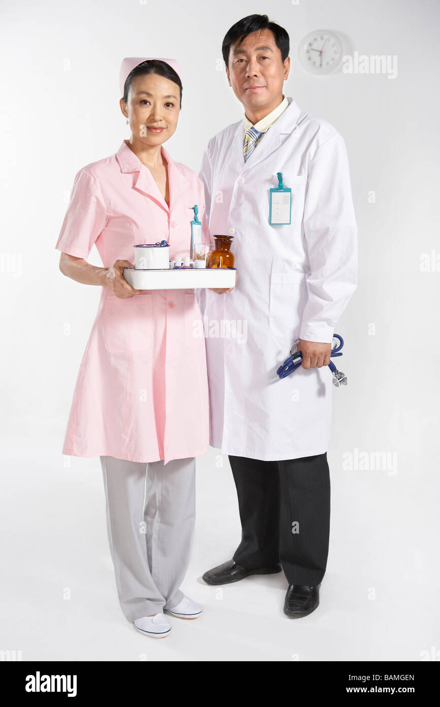 Doctor And Nurse With Medicine Tray Stock Photo - Alamy