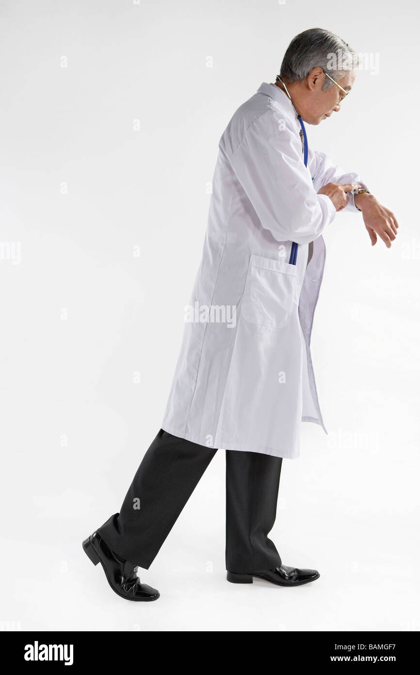 Doctor Looking At His Wristwatch Stock Photo - Alamy