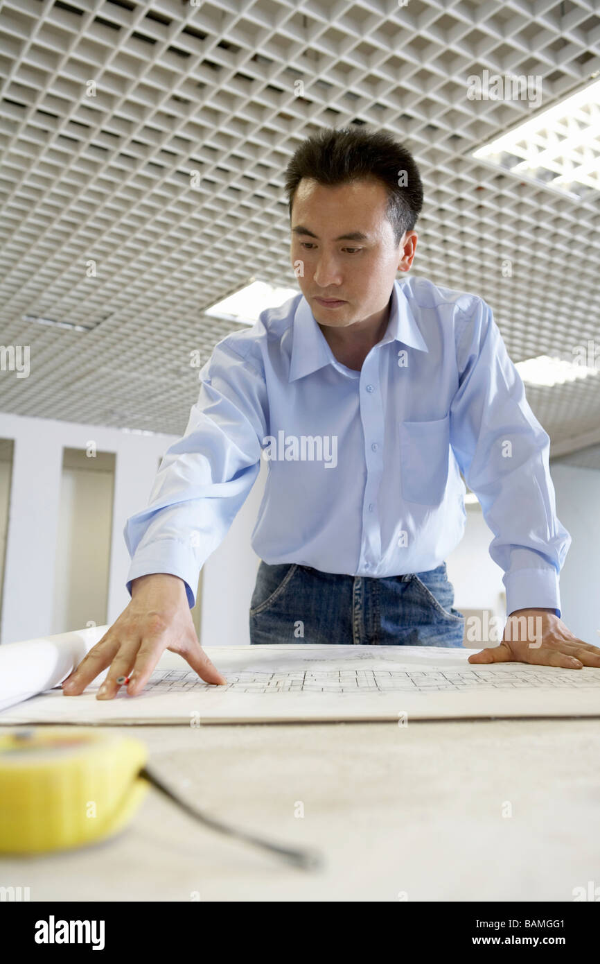 Architect Looking At Building Plans Stock Photo - Alamy