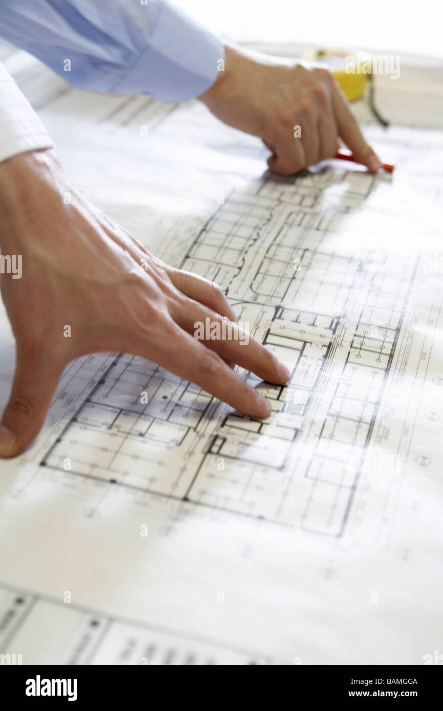 Architects Pointing At Building Plans Stock Photo - Alamy