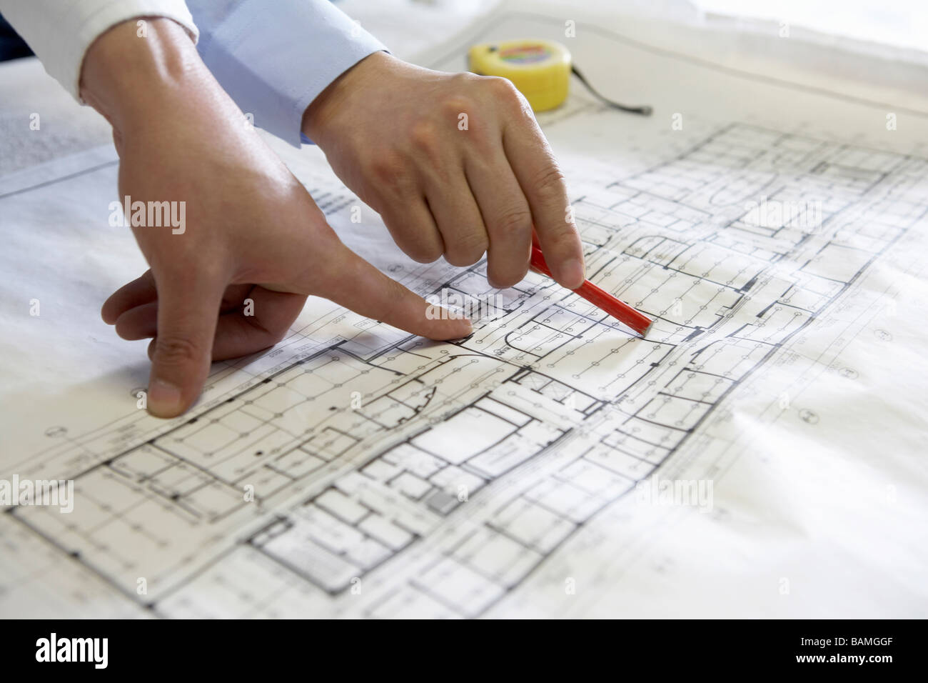 Architects Pointing At Building Plans Stock Photo - Alamy