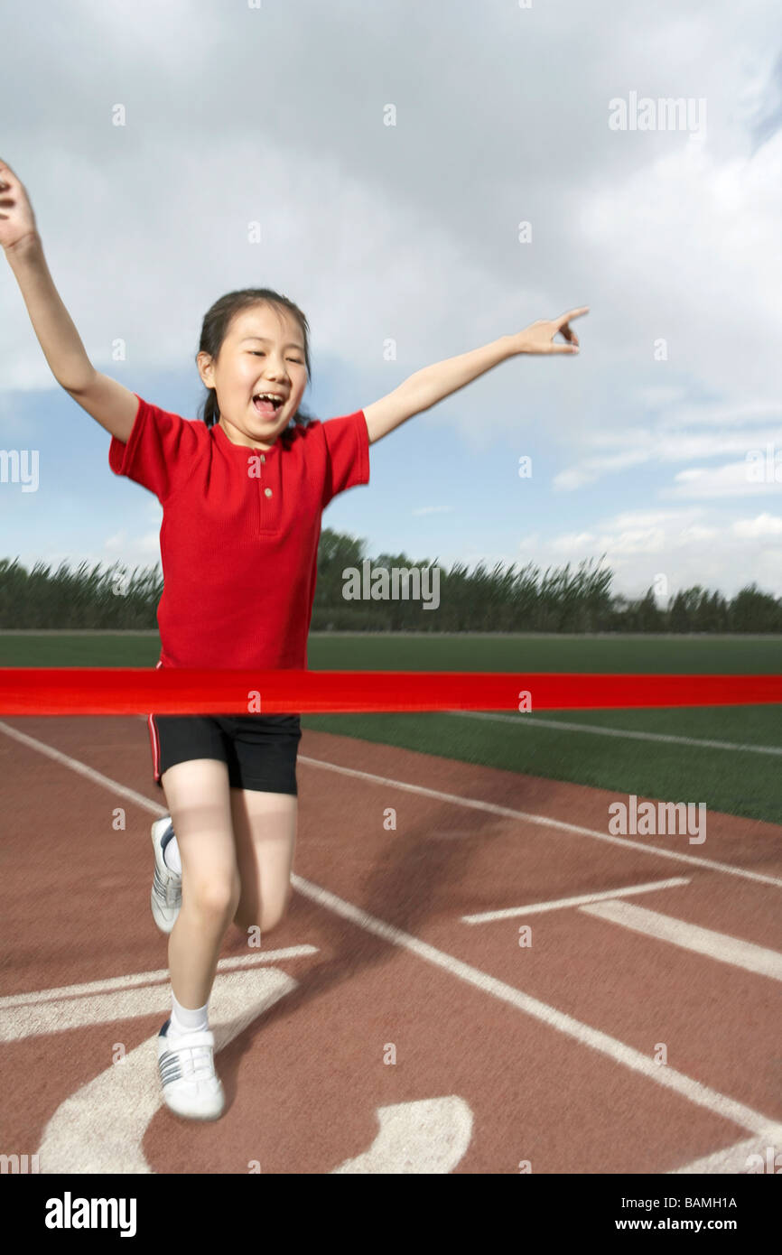 Girl Winning A Running Race And Cheering Happily Stock Photo - Alamy