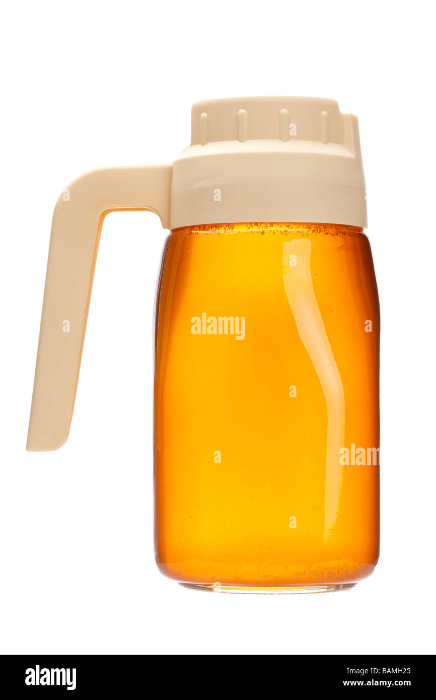 Pitcher full of honey isolated on white background Stock Photo - Alamy