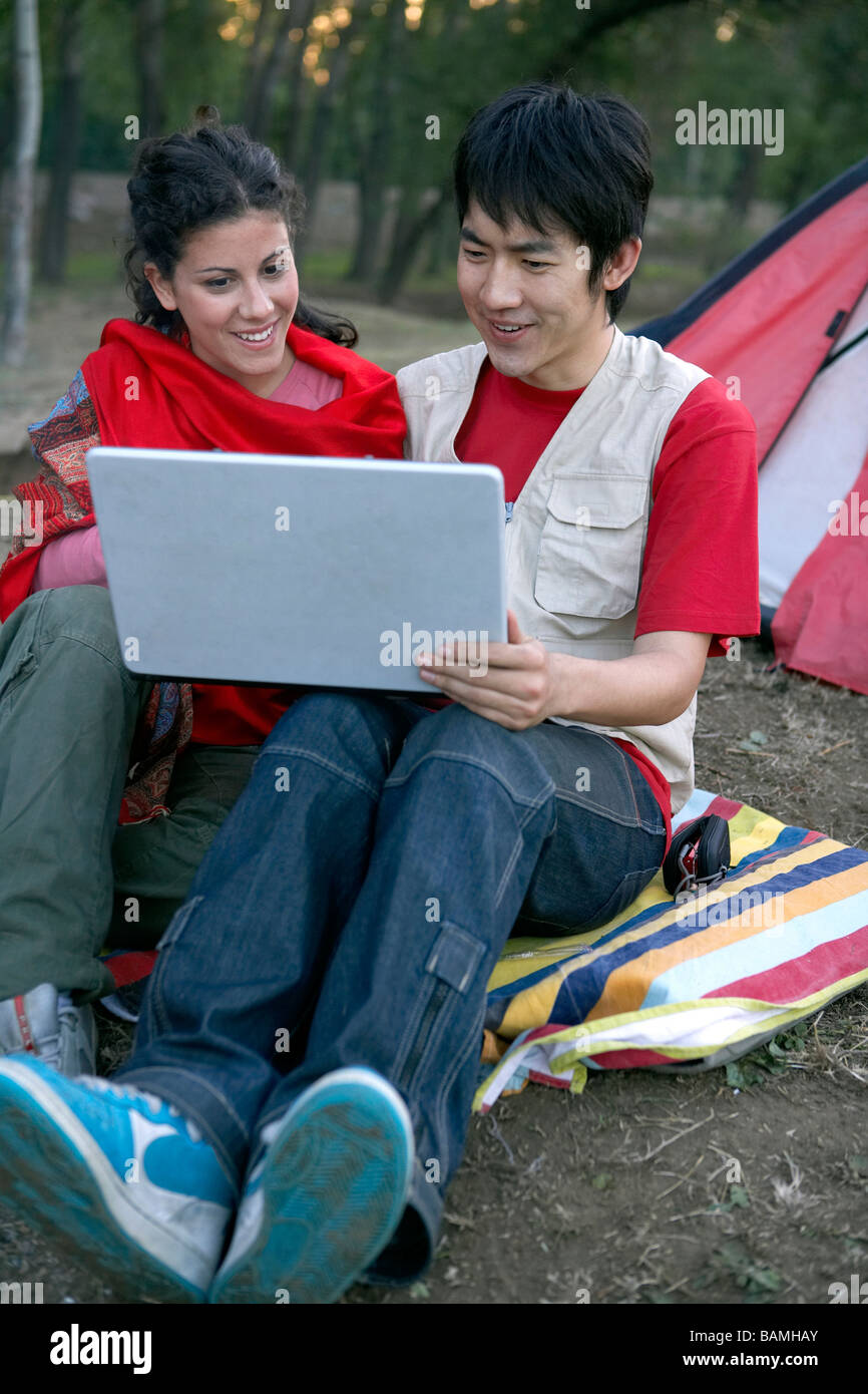 Young Couple Camping With Computer Stock Photo - Alamy