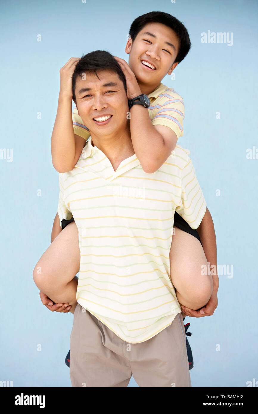 Father Giving Son A Piggy Back Stock Photo - Alamy