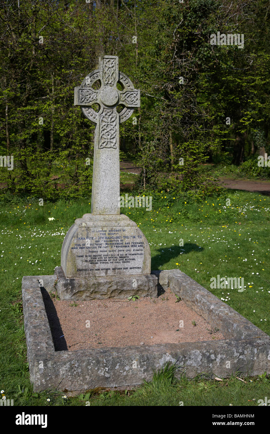 Irish celtic cross and grave in the graveyard of antrim castle Stock ...