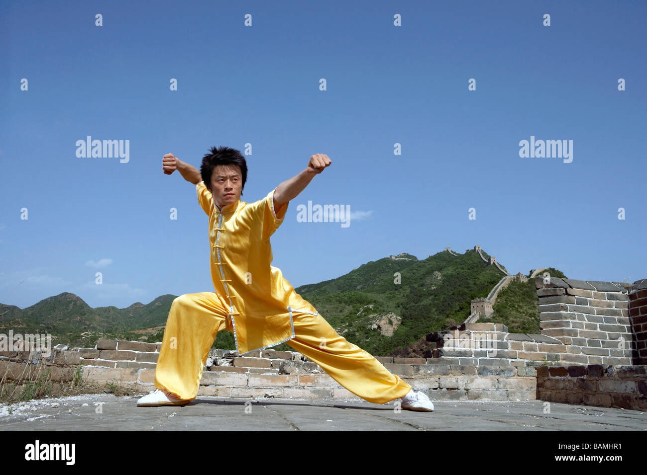 Portrait Of Young Man Practicing Martial Arts On The Great Wall Of ...