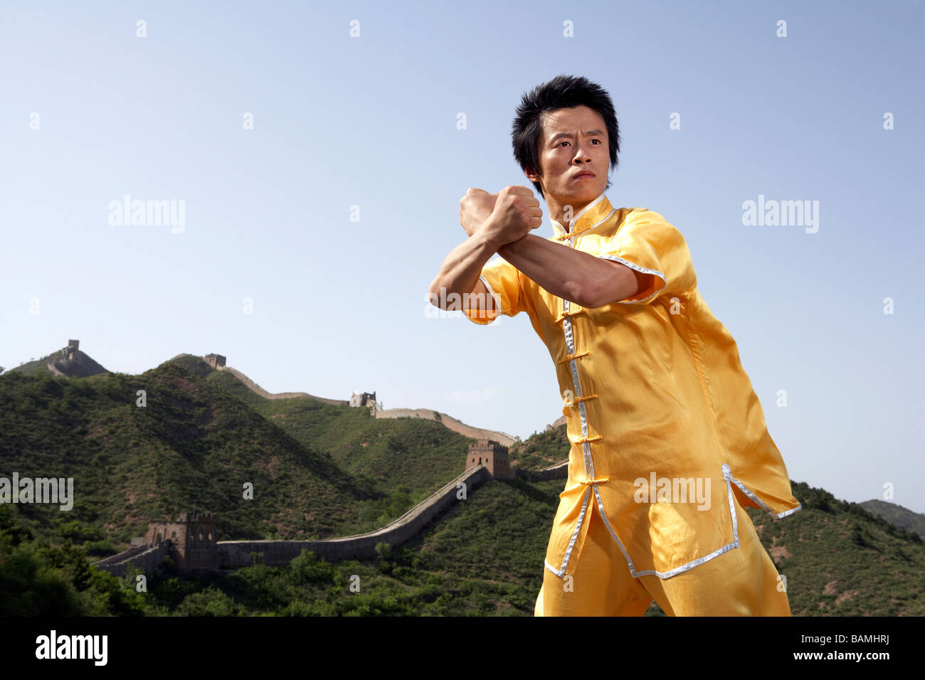 Portrait Of Young Man Practicing Martial Arts On The Great Wall Of ...