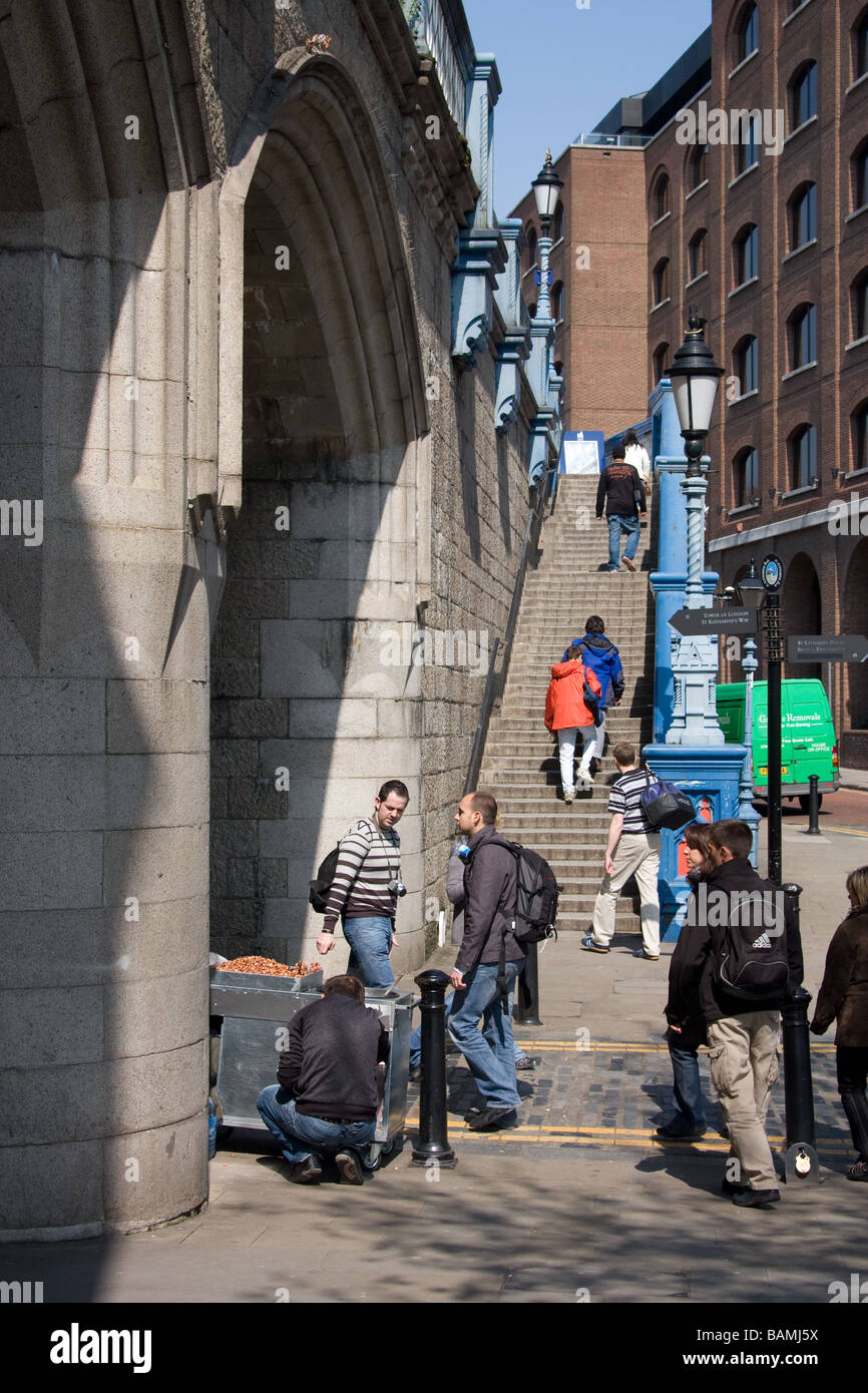 tourists snack street seller steps tower bridge thames path north bank ...