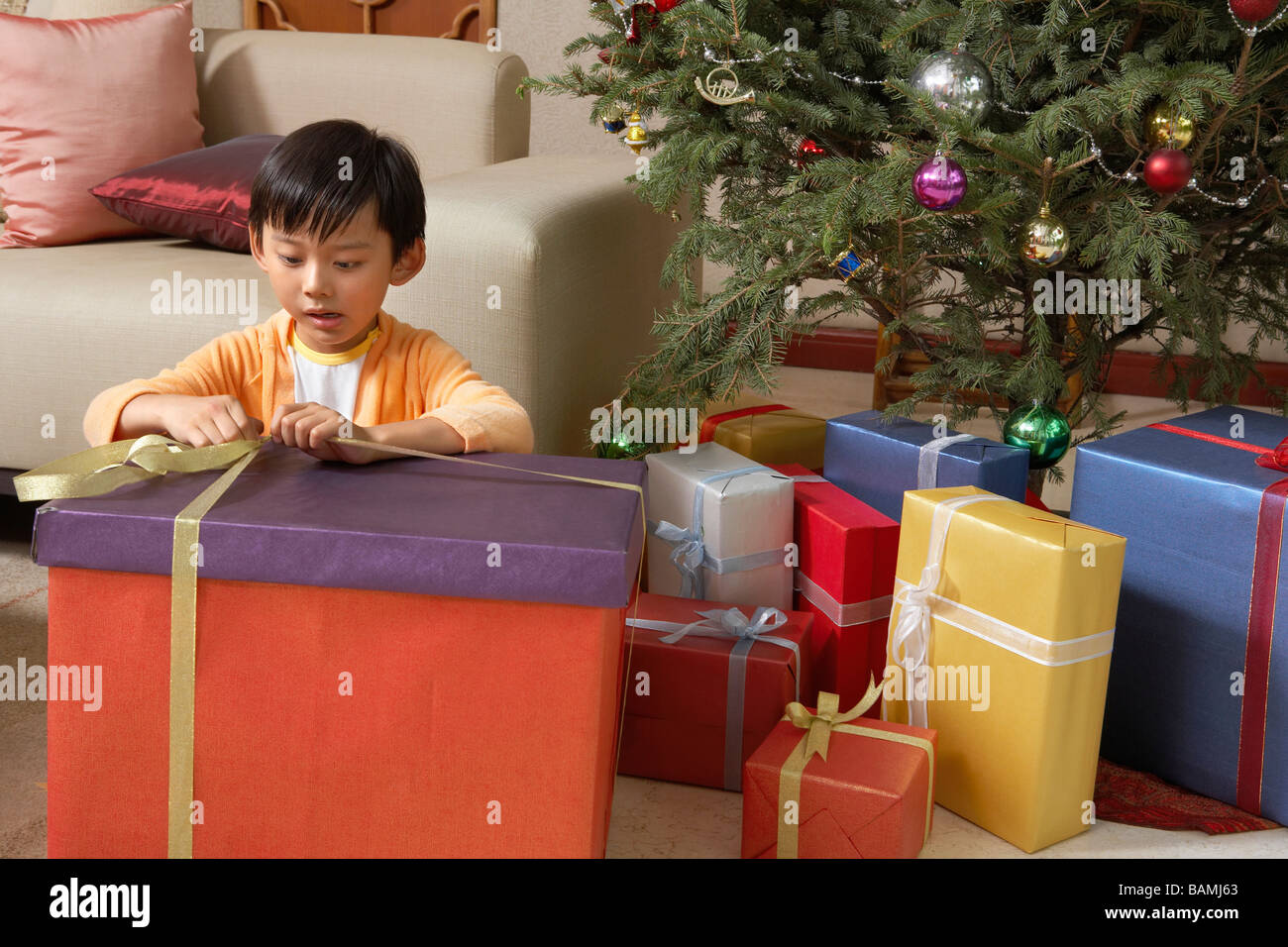 Young Boy Excitedly Opening Christmas Presents Stock Photo - Alamy
