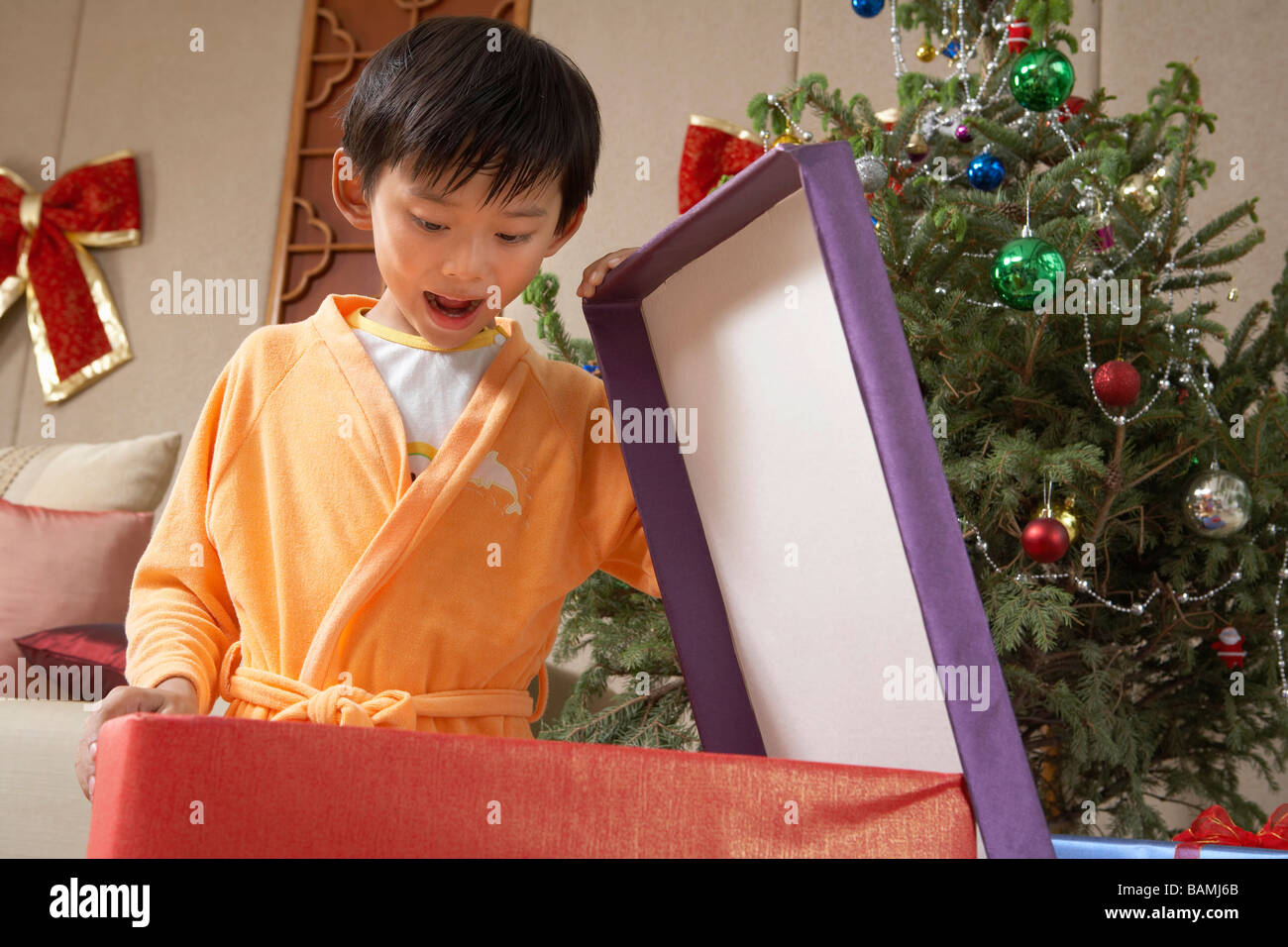 Young Boy Excitedly Opening Christmas Presents Stock Photo - Alamy