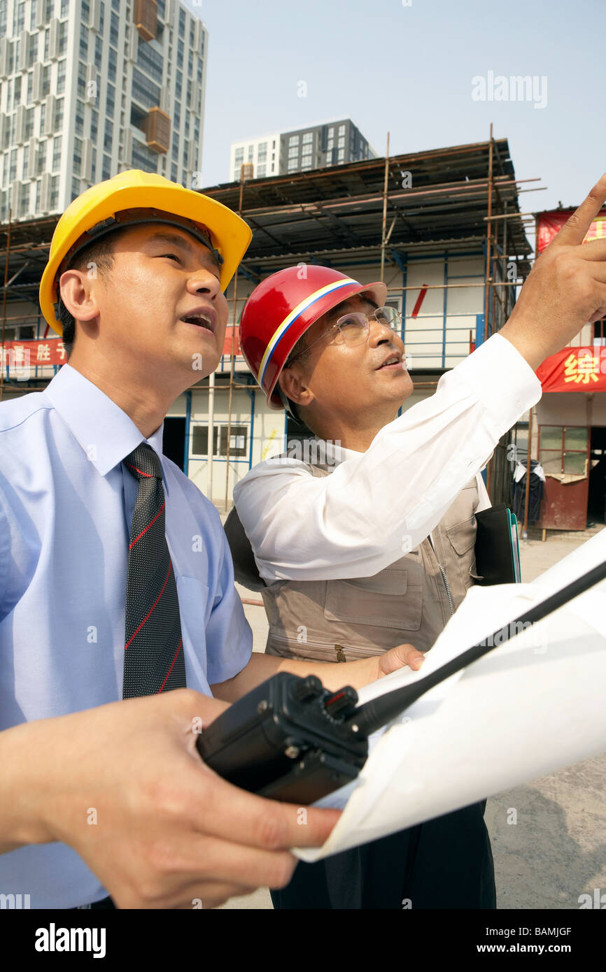 Construction Contractors Looking Into The Distance Stock Photo - Alamy