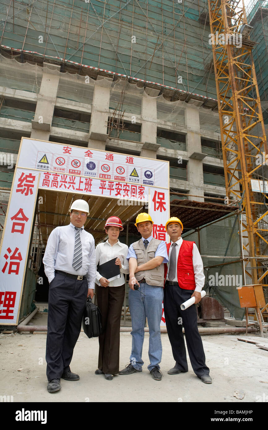 Construction Contractors Standing On Building Site Stock Photo - Alamy