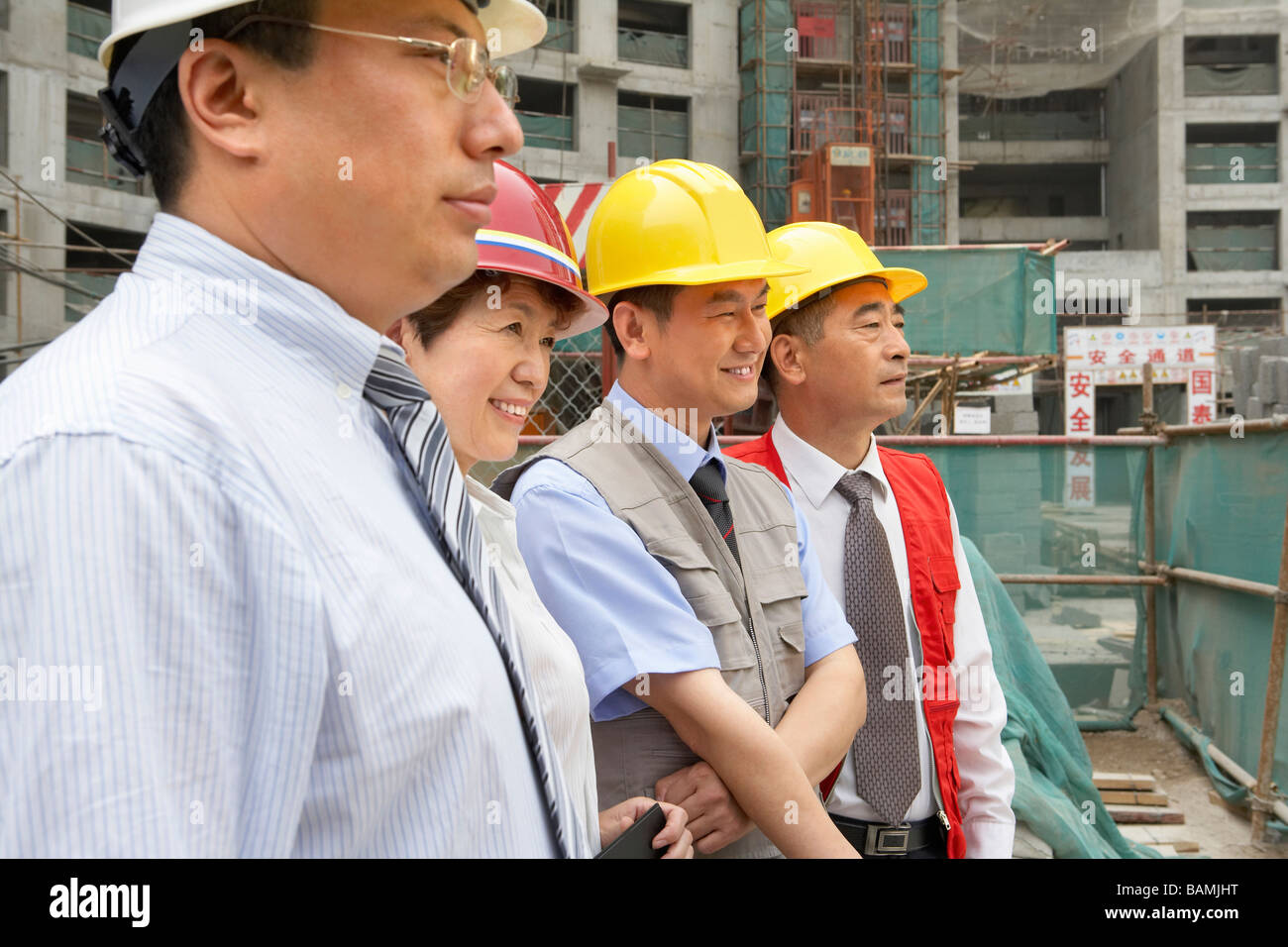 Construction Contractors Standing On Building Site Stock Photo - Alamy