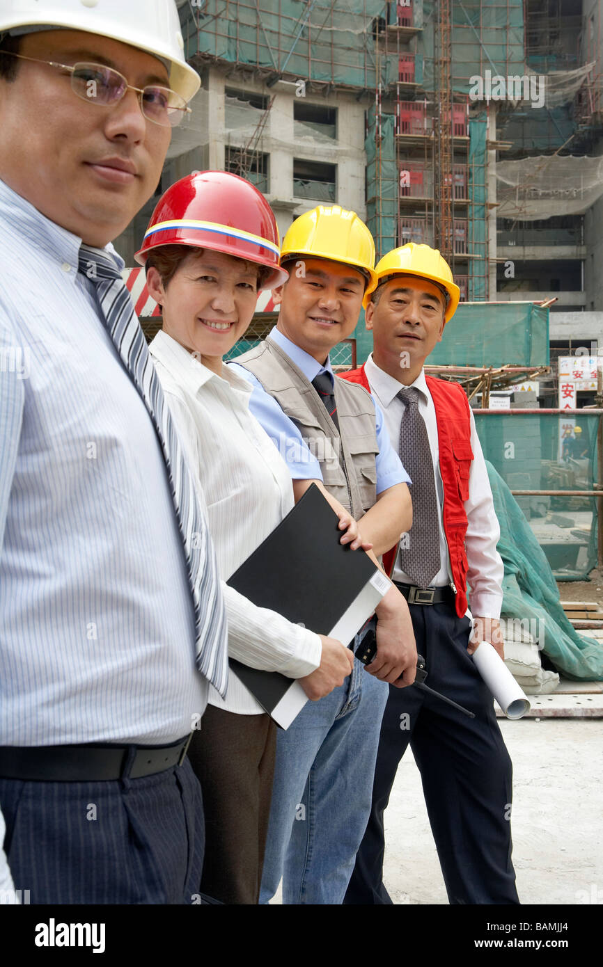 Construction Contractors Standing On Building Site Stock Photo - Alamy