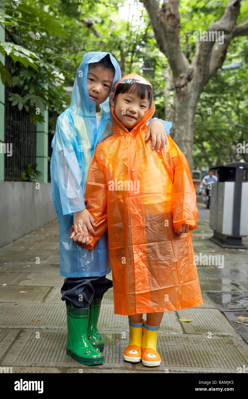 Young Children In The Rain With Raincoats Stock Photo - Alamy