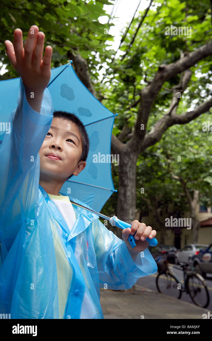 Young Child In The Rain With An Umbrella Stock Photo - Alamy